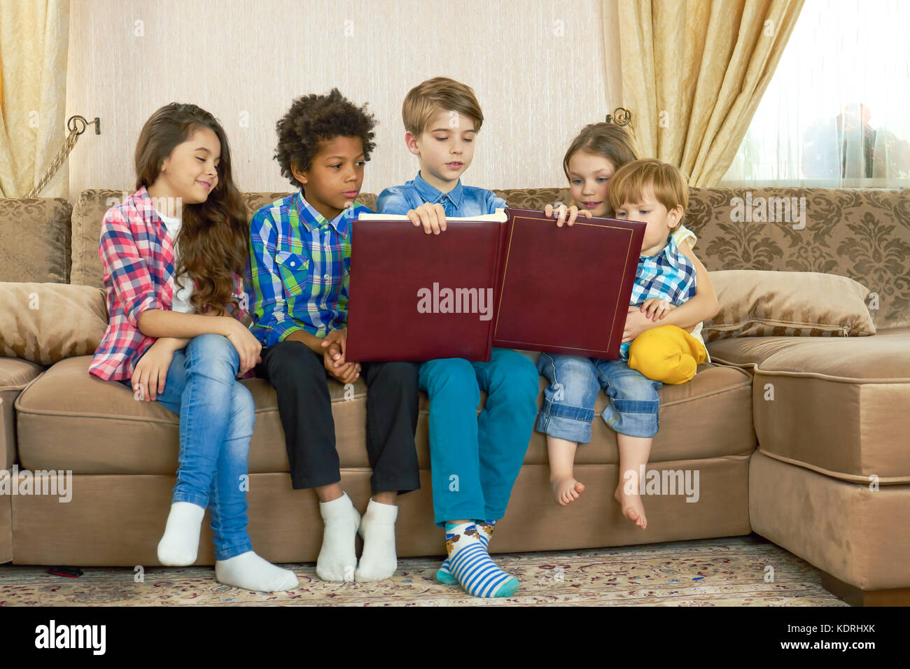 Children with a big book Stock Photo - Alamy
