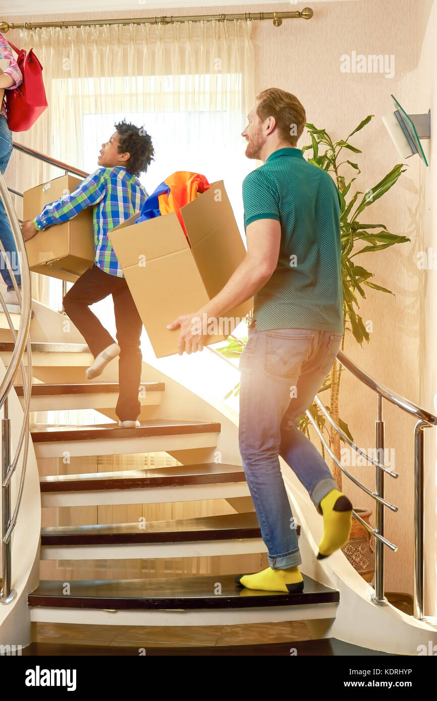 People with boxes walking upstairs Stock Photo - Alamy