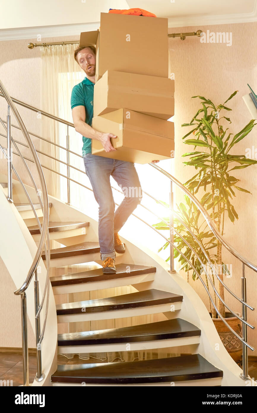 Man carrying stack of boxes Stock Photo - Alamy
