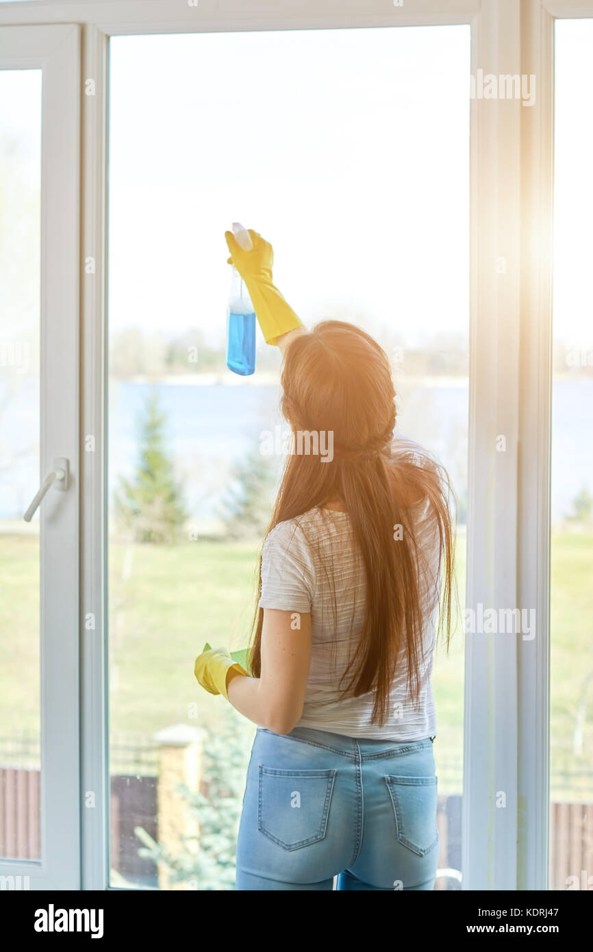 Young woman cleaning window Stock Photo - Alamy