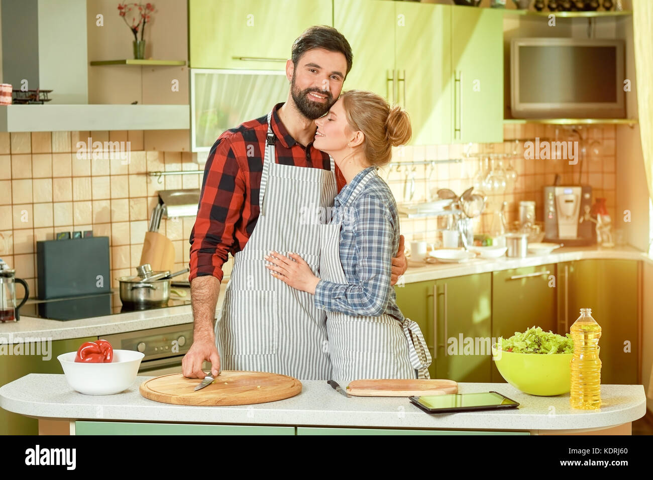 Young couple smiling, kitchen Stock Photo - Alamy