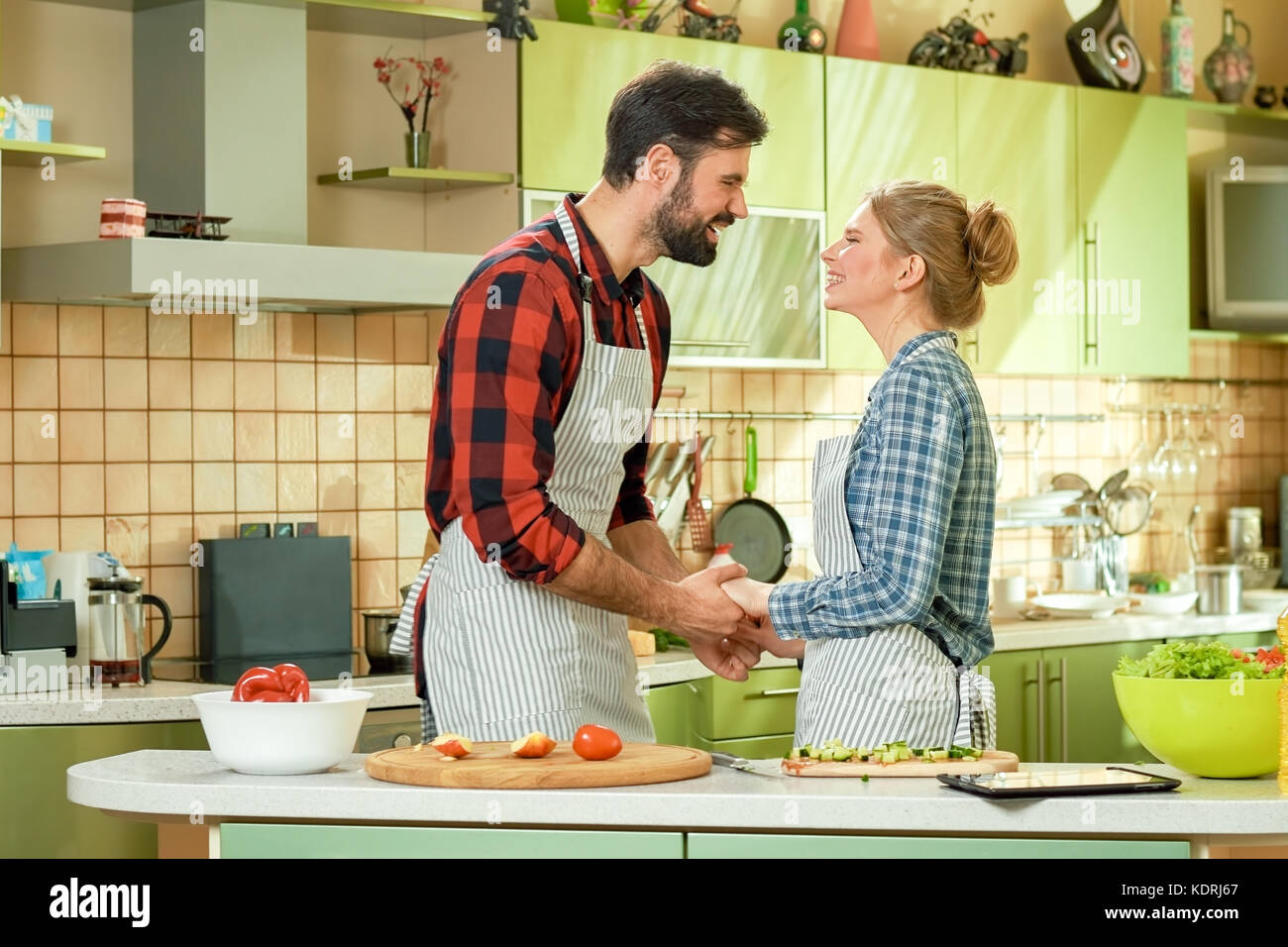 Couple holding hands, kitchen Stock Photo - Alamy