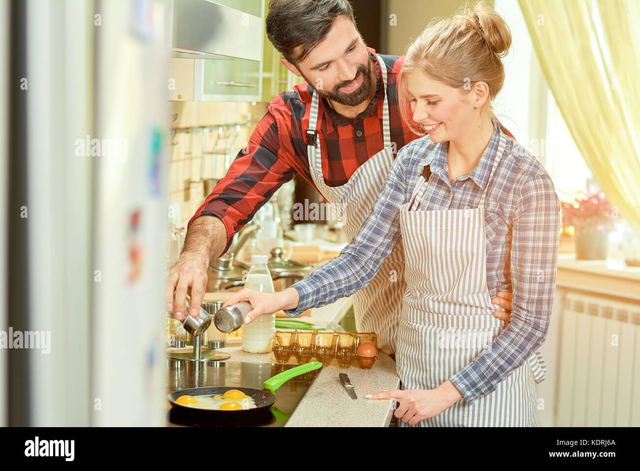 Caucasian man and woman cooking Stock Photo - Alamy