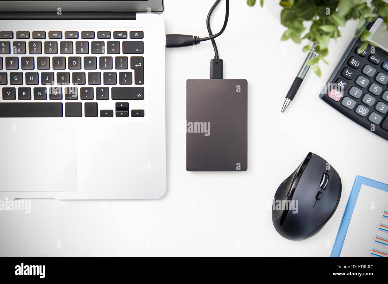 External backup disk hard drive connected to laptop. hard drive backup ...