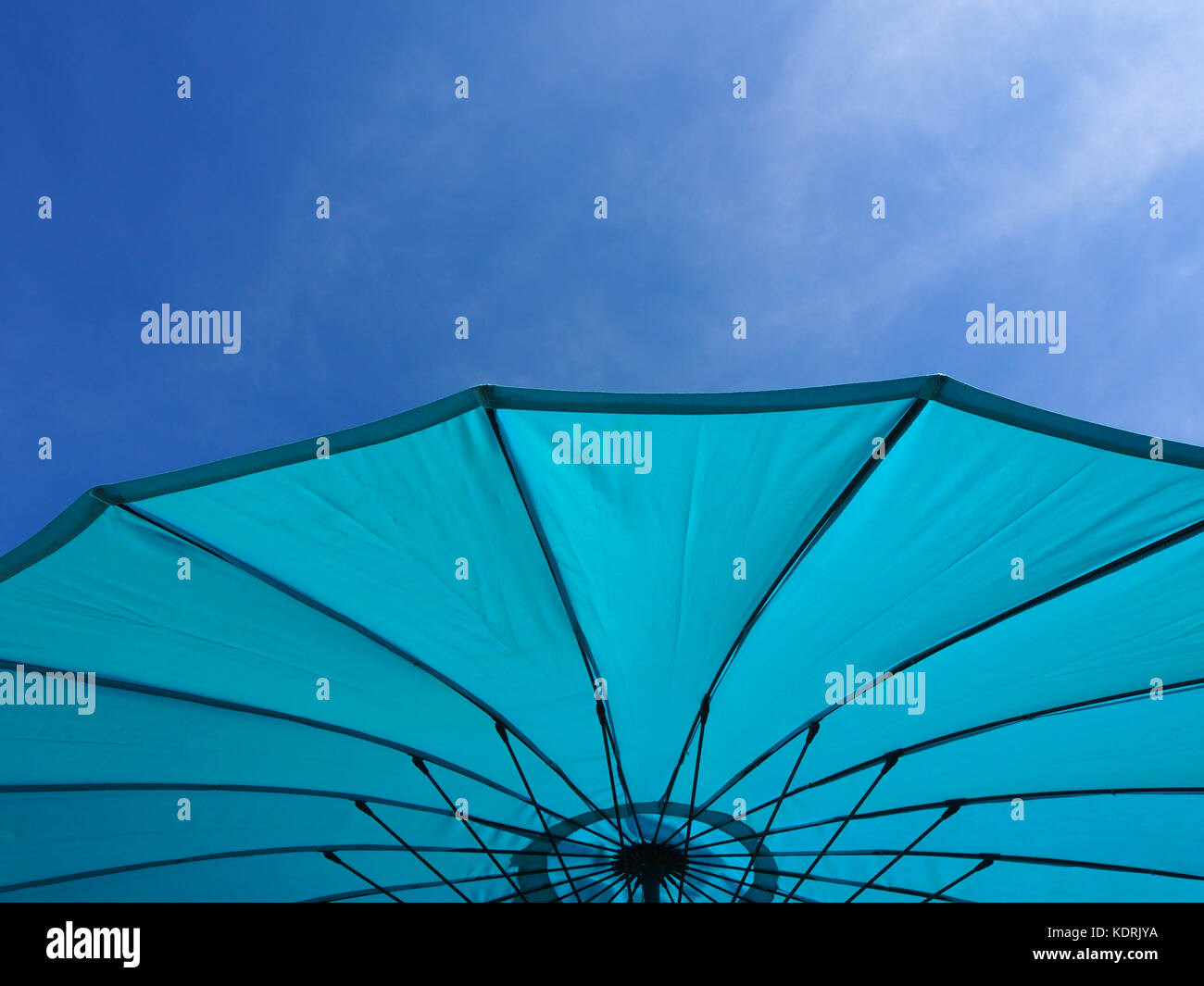 A Blue parasol against a blue sky Stock Photo - Alamy