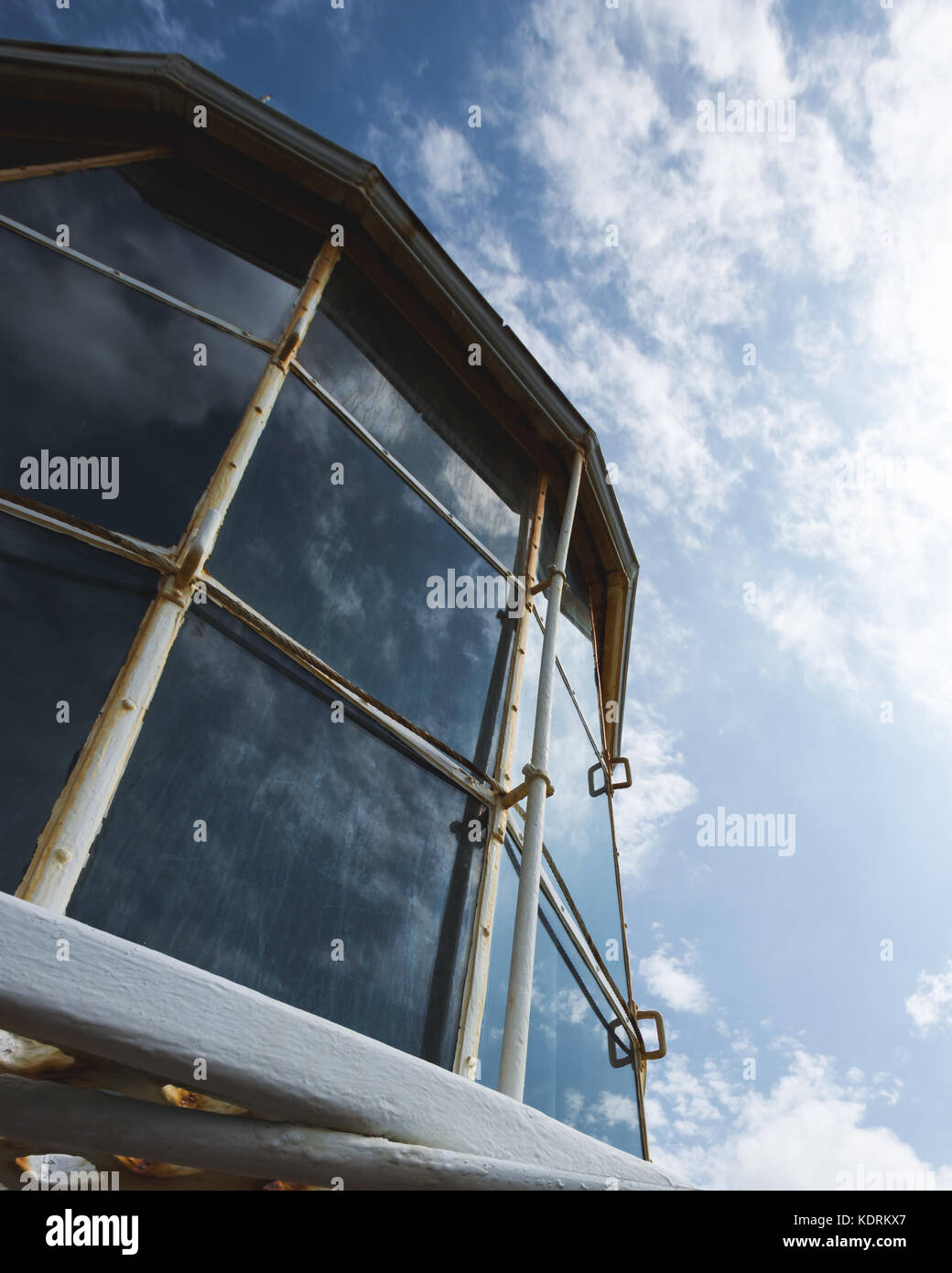 Up close photo of the windows at top of a lighthouse. Daytime with ...