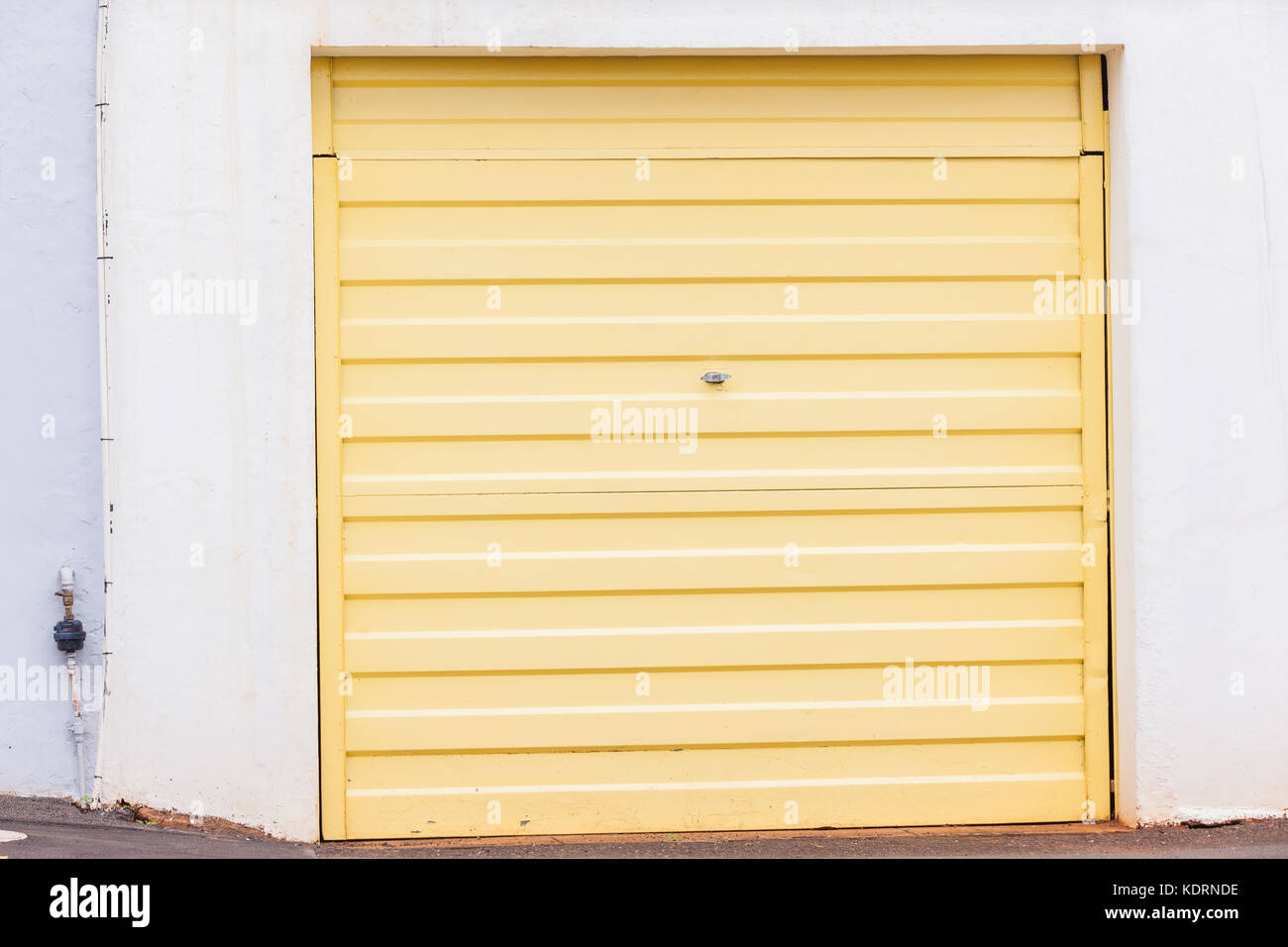 Yellow garage door road entrance for vehicle Stock Photo - Alamy