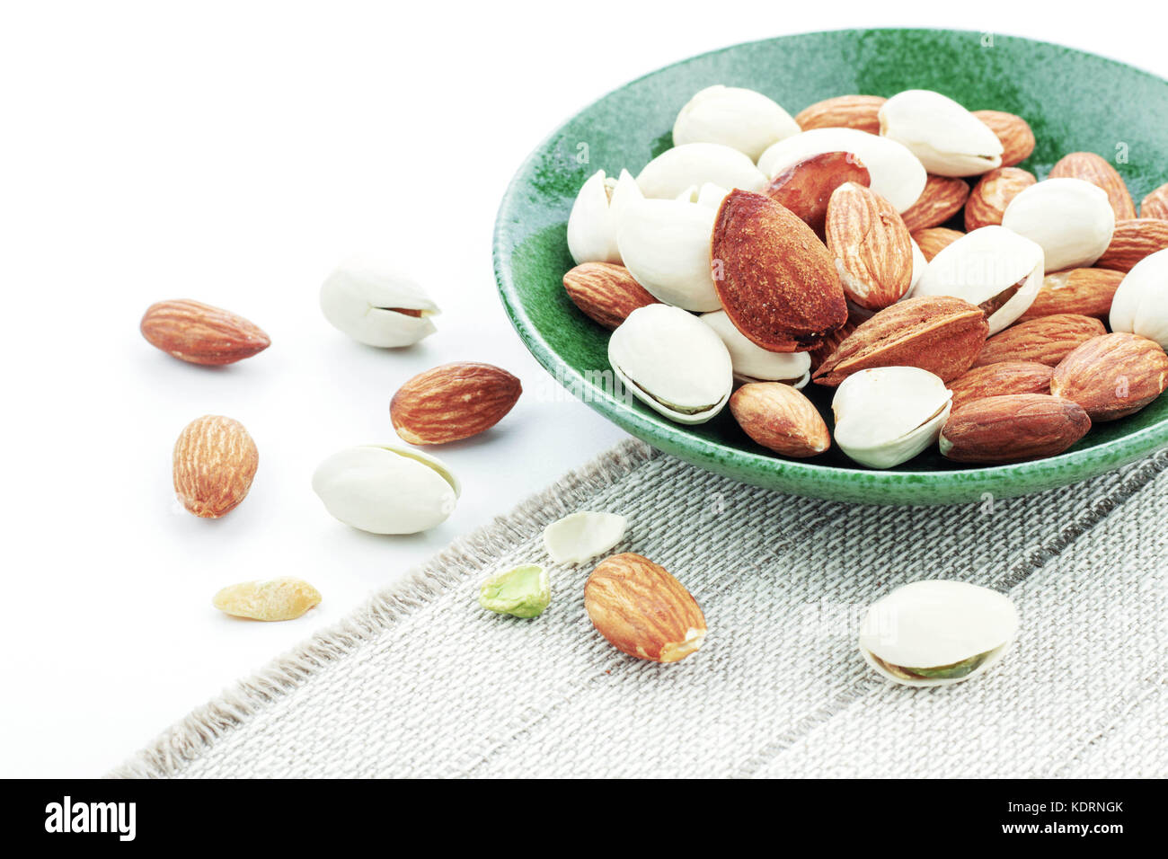 Almond on plate with a white background Stock Photo - Alamy