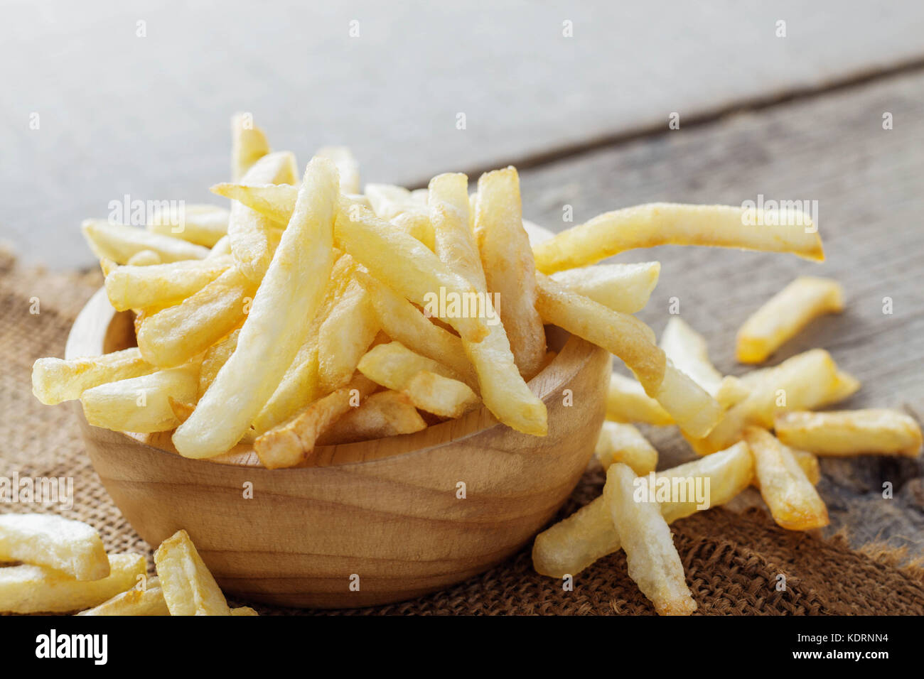 French fries in a bowl on wooden floor Stock Photo - Alamy