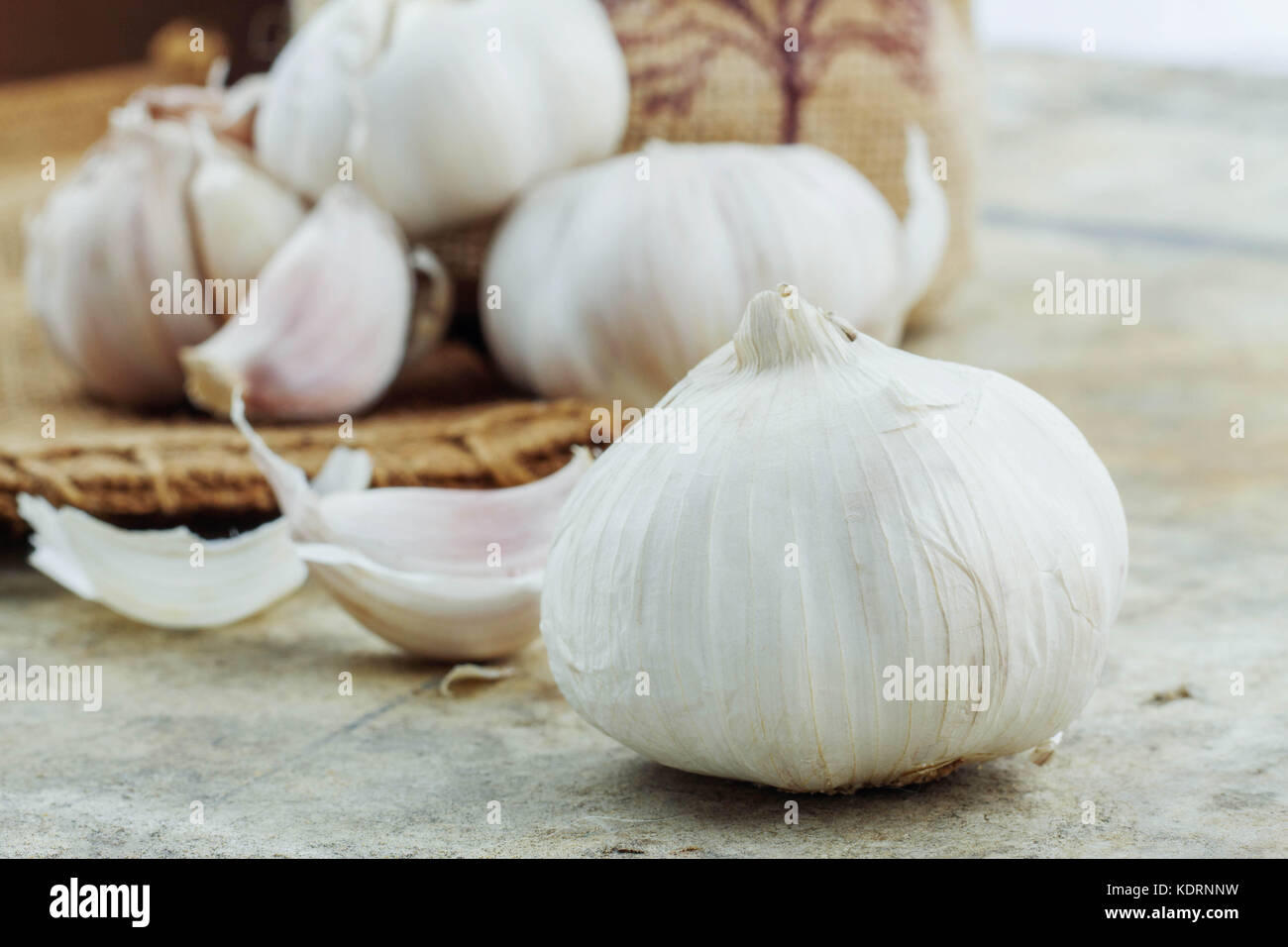Dry Garlic on the old cement and sack Stock Photo - Alamy