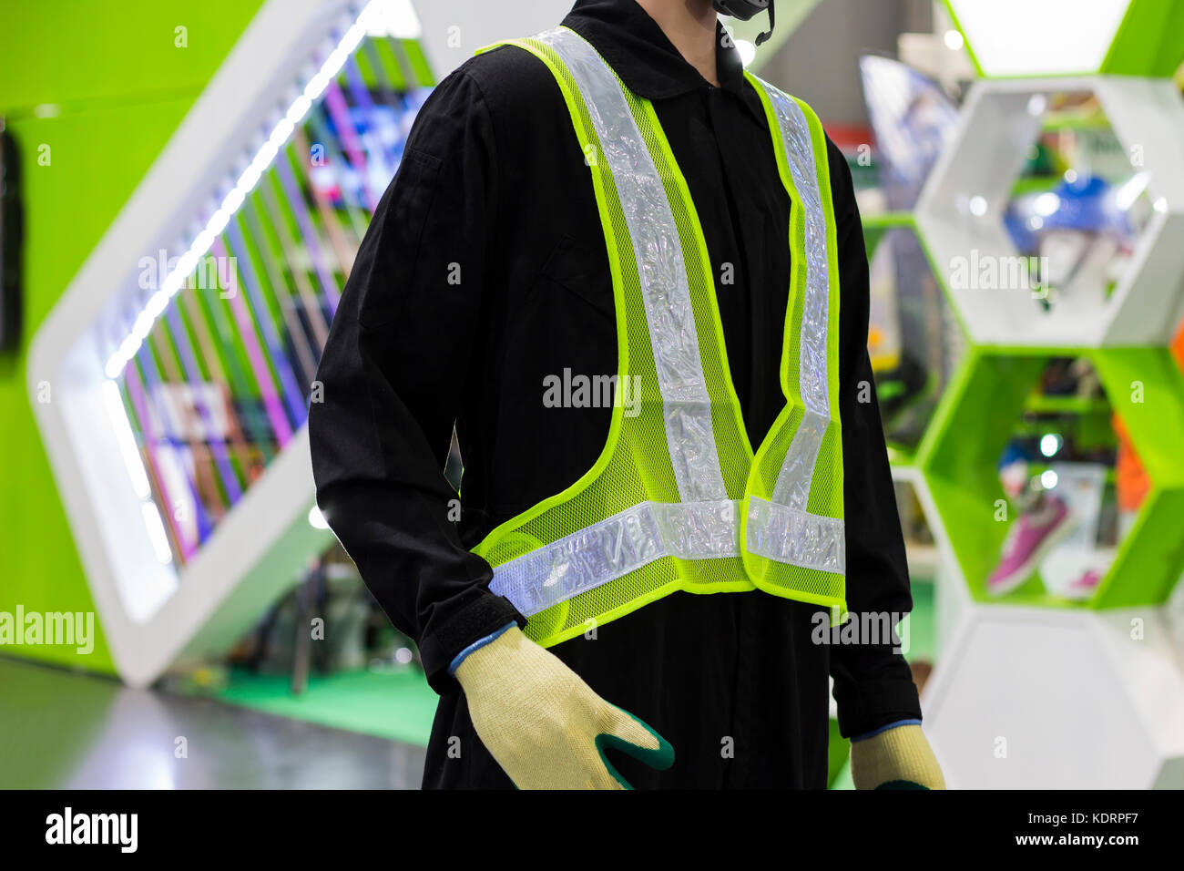 a yellow mesh safety vest with reflective tape Stock Photo - Alamy