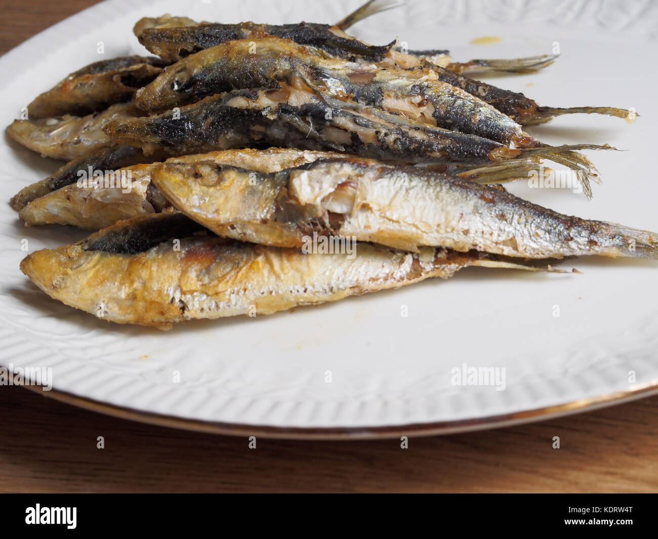 Fried small sardine on a plate Stock Photo - Alamy