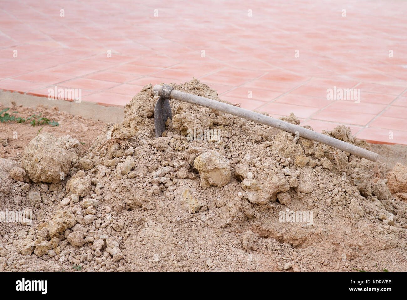Pile of earth and a digging tool Stock Photo - Alamy