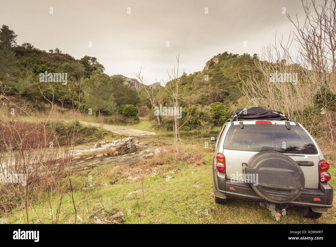 Off road car crossing river.Road trip in undiscovered places off beaten ...