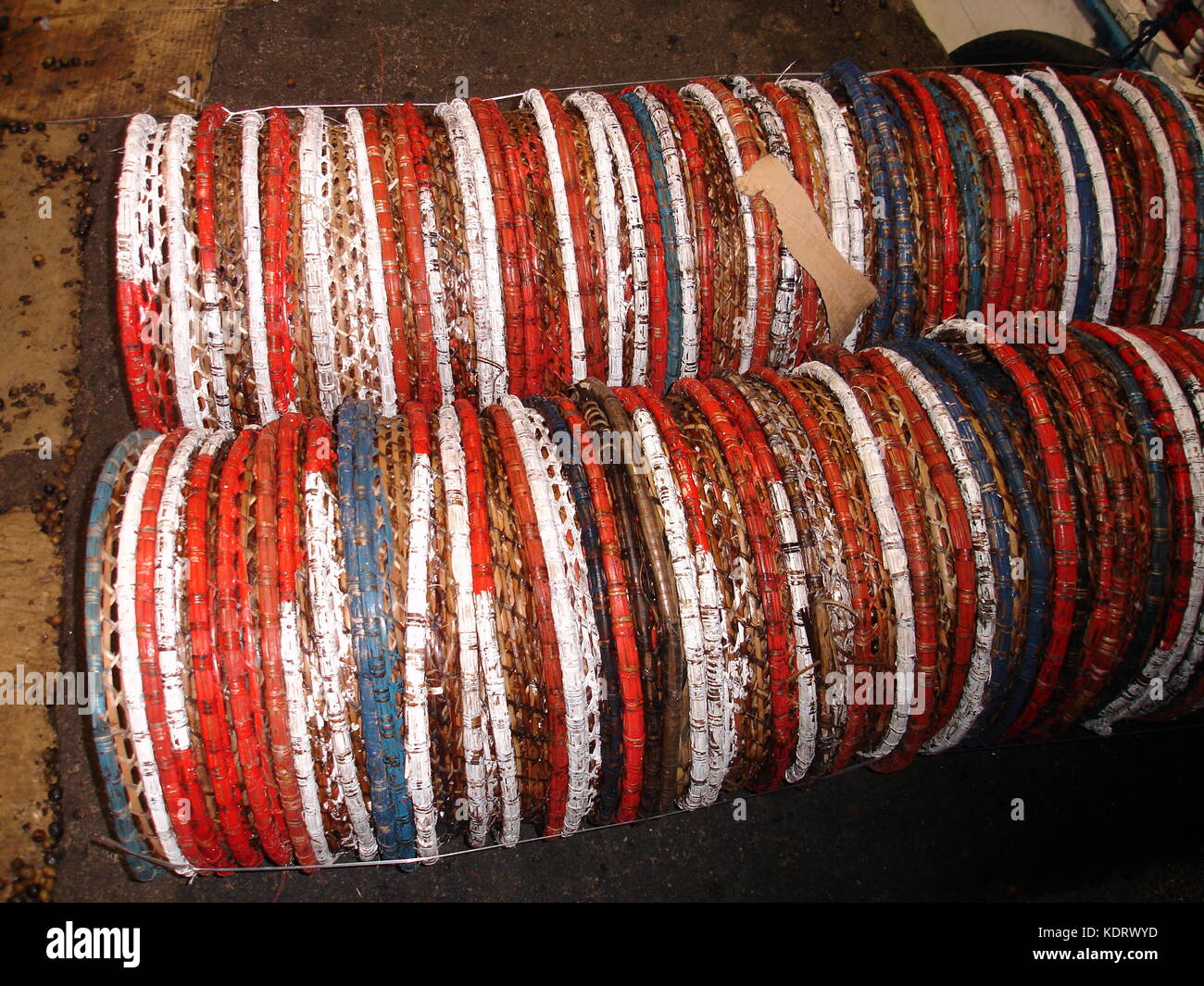 Several red, blue and white painted empty baskets of acai berry fruit ...