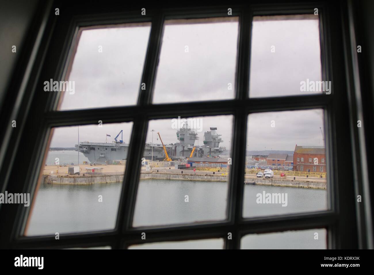 A view of the Royal Navy flagship HMS Queen Elizabeth through a window ...