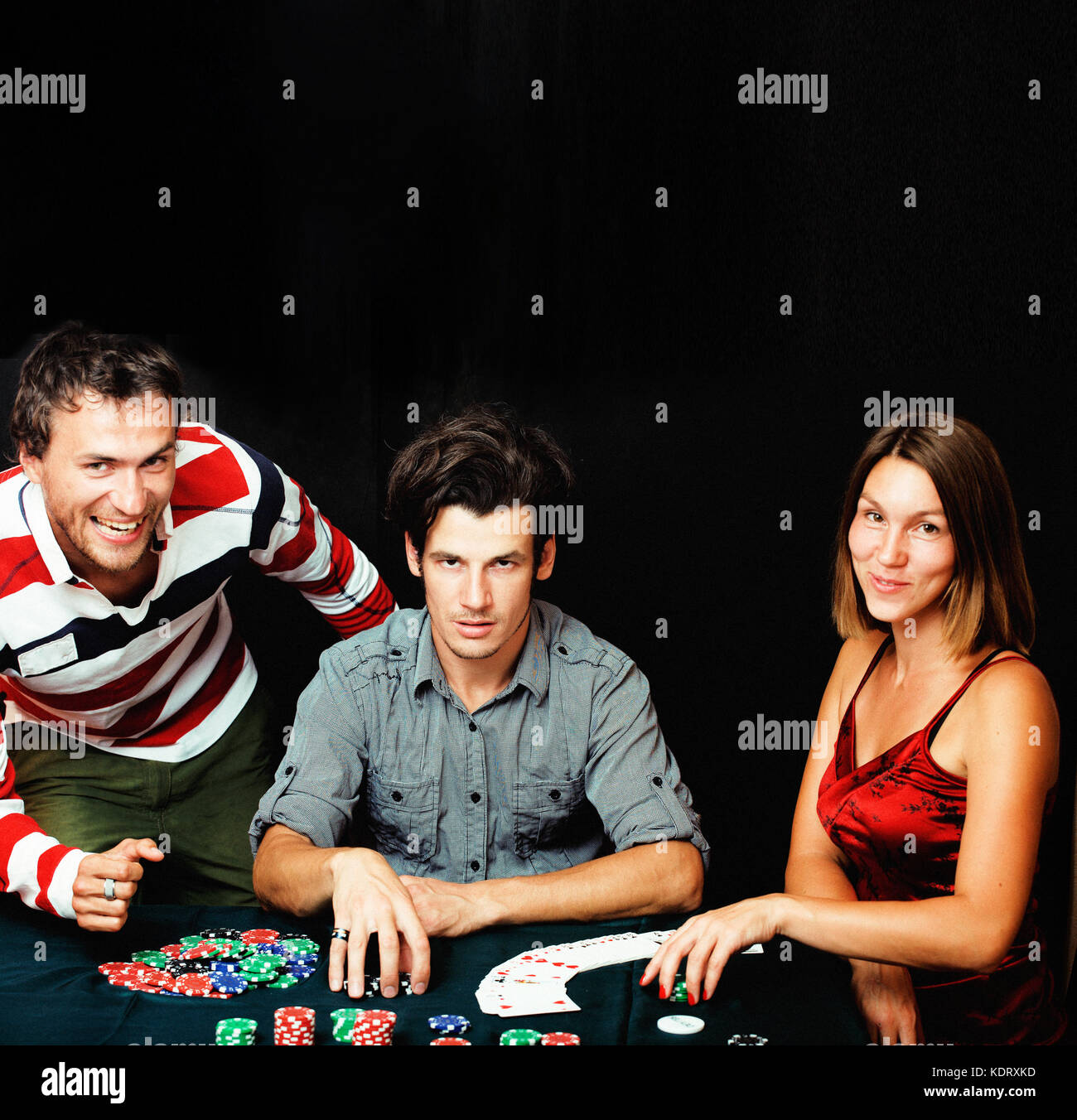 young people playing poker on black background Stock Photo - Alamy