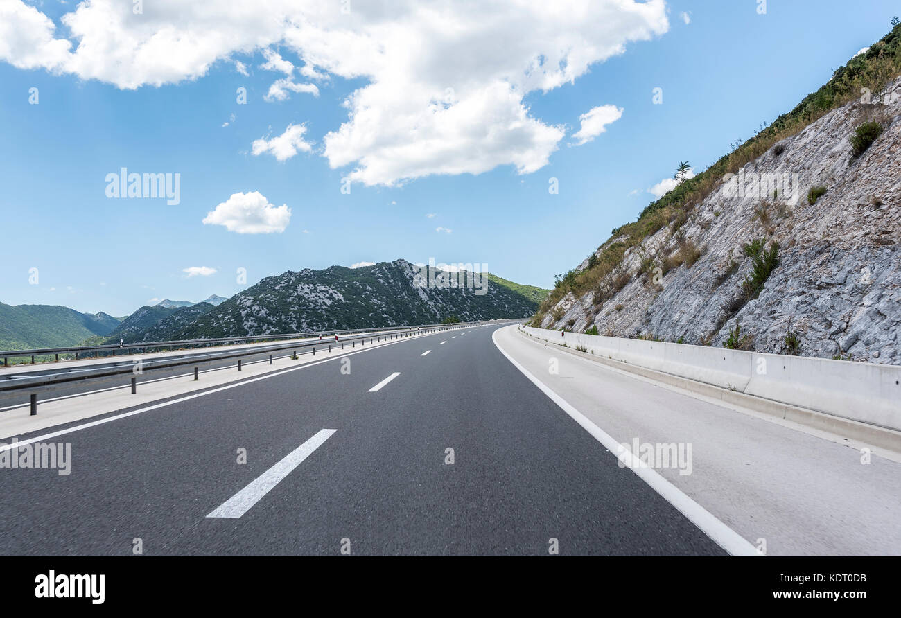 High-speed country road among the mountains Stock Photo - Alamy