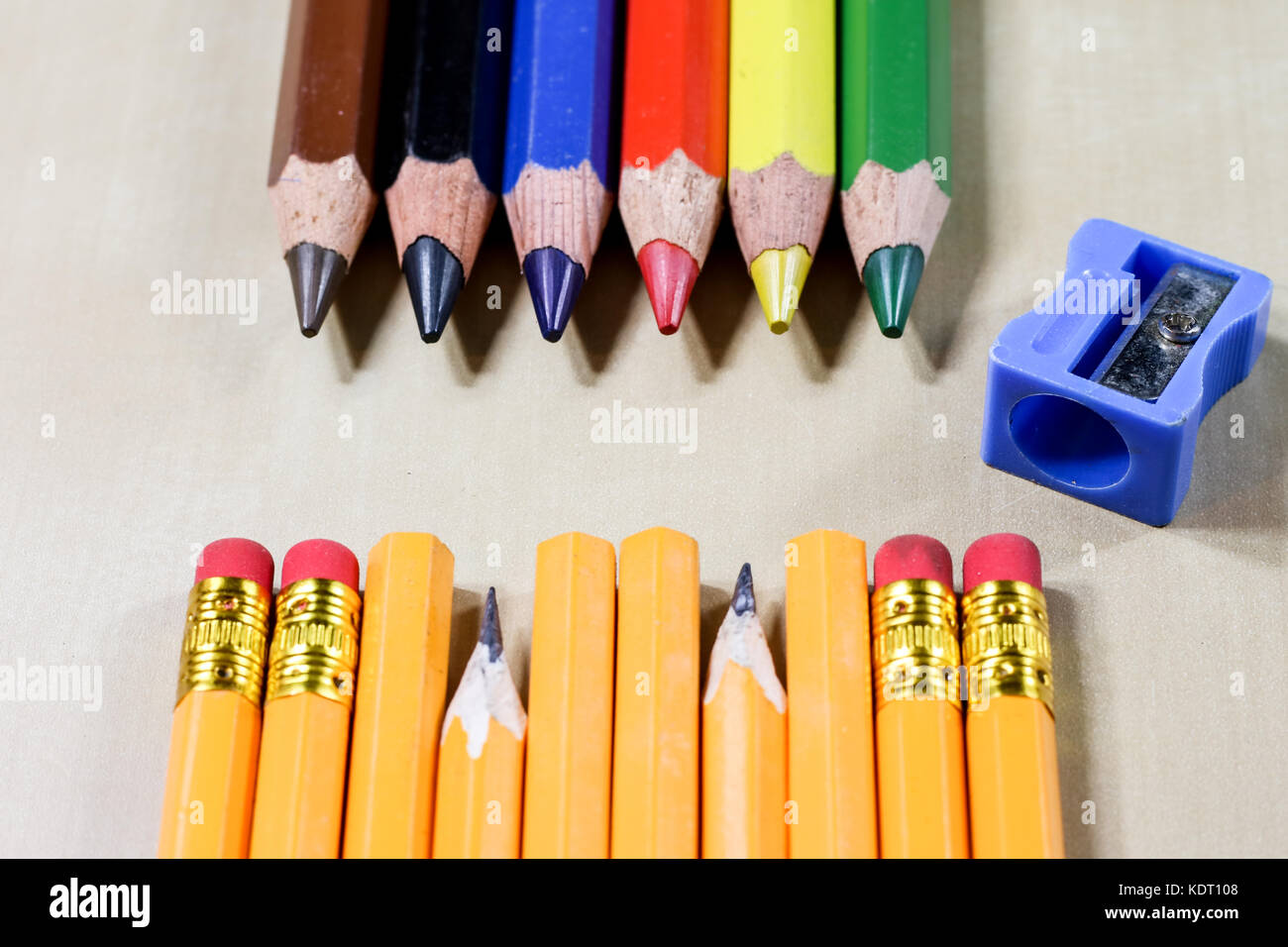 crayons and pencil sharpener on a wooden office table. Crayons with ...