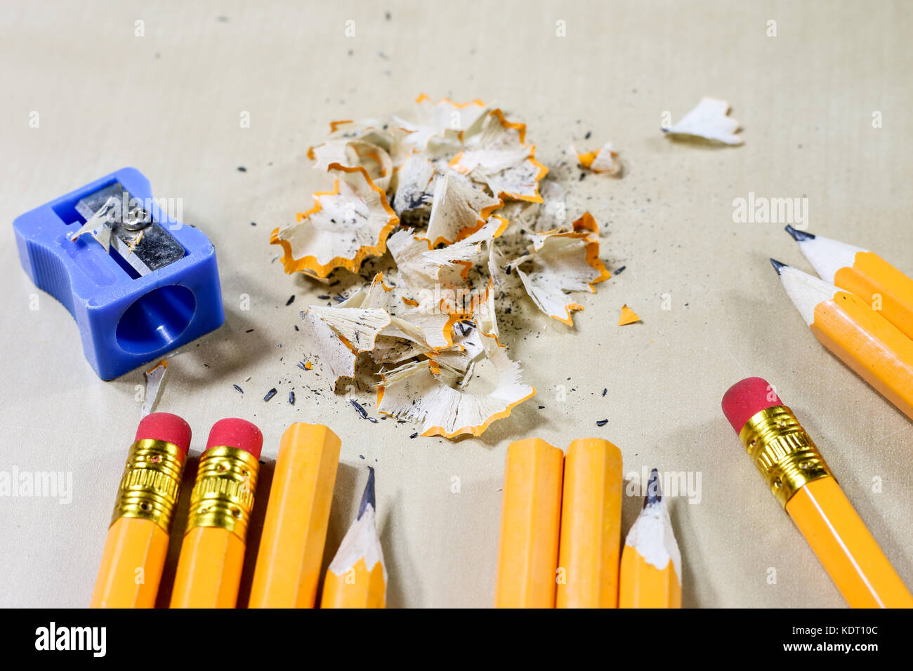 crayons and pencil sharpener on a wooden office table. Crayons with ...