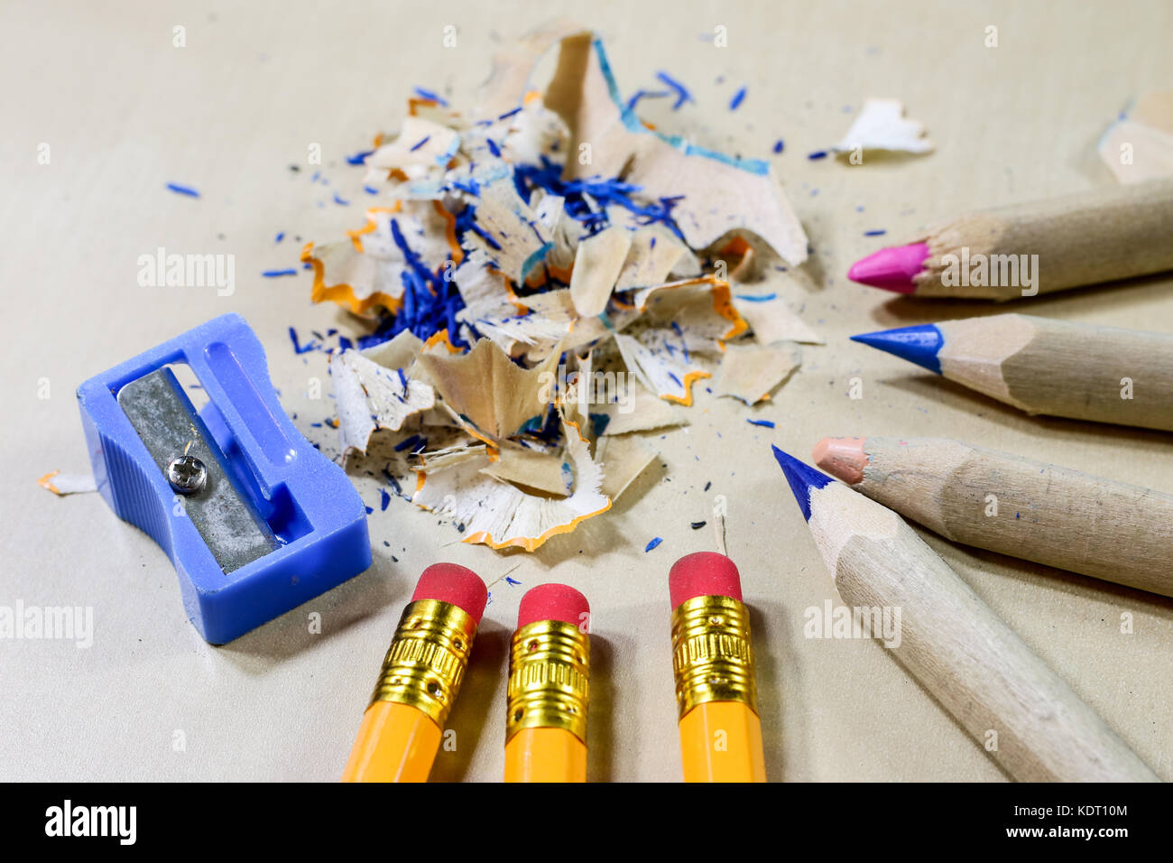 crayons and pencil sharpener on a wooden office table. Crayons with ...