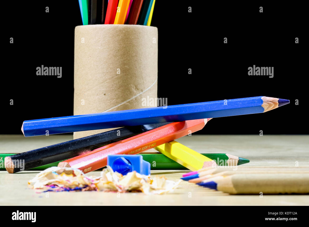 crayons and pencil sharpener on a wooden office table. Crayons with ...