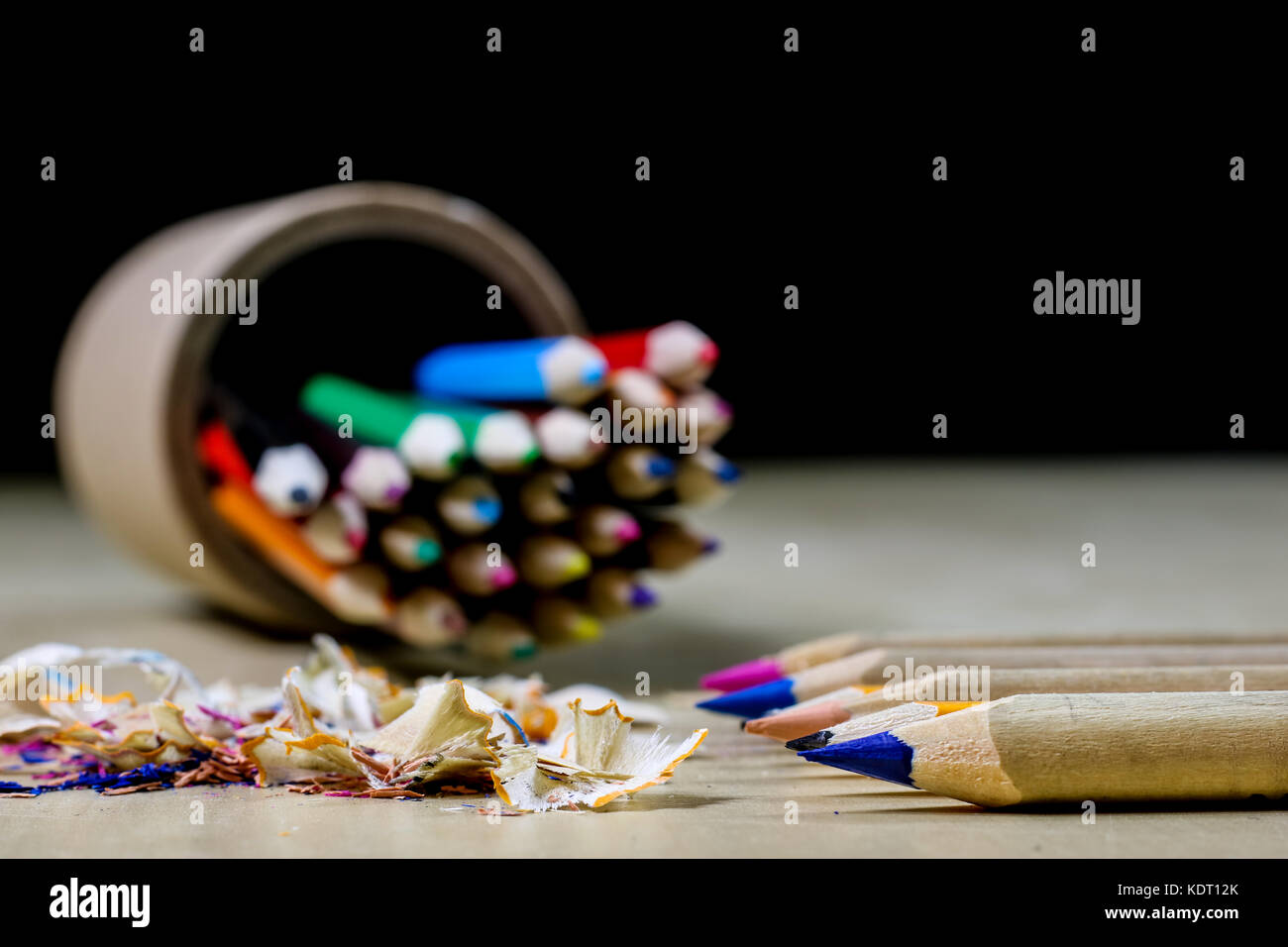 crayons and pencil sharpener on a wooden office table. Crayons with ...