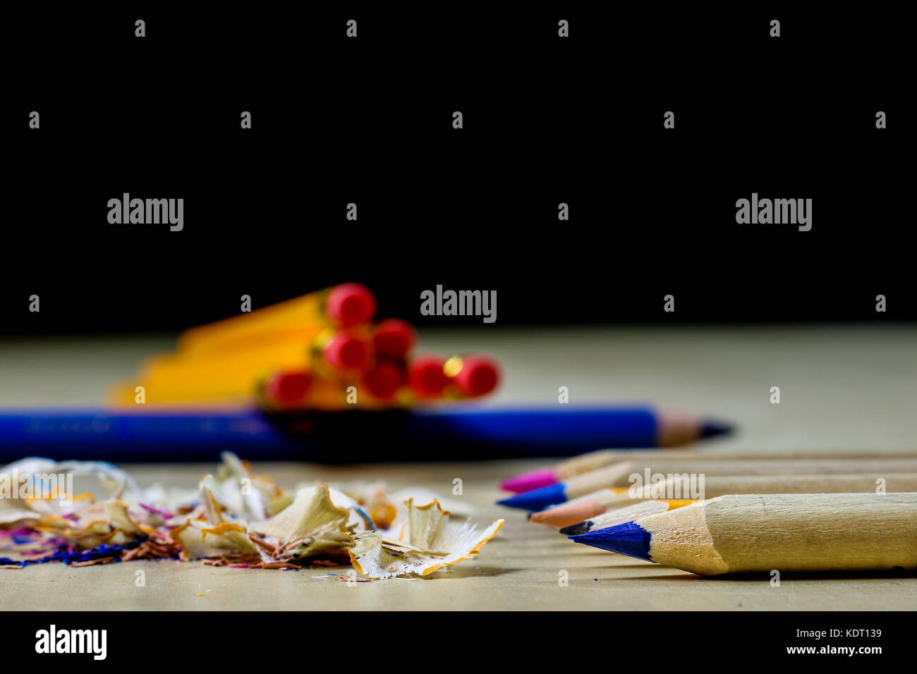 crayons and pencil sharpener on a wooden office table. Crayons with ...