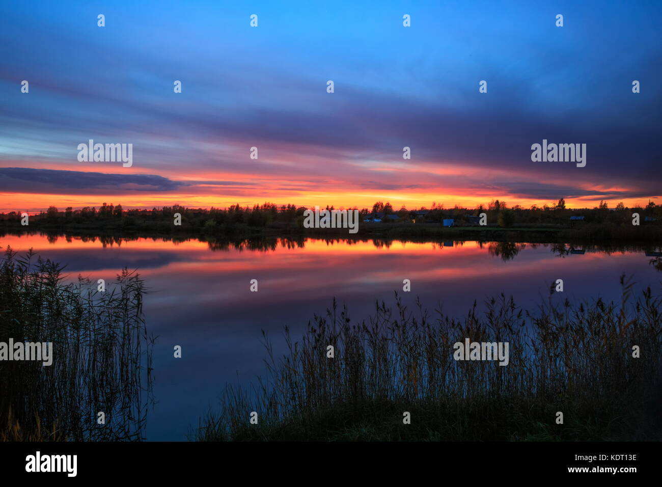 Sunset scene over lake water surface Stock Photo - Alamy