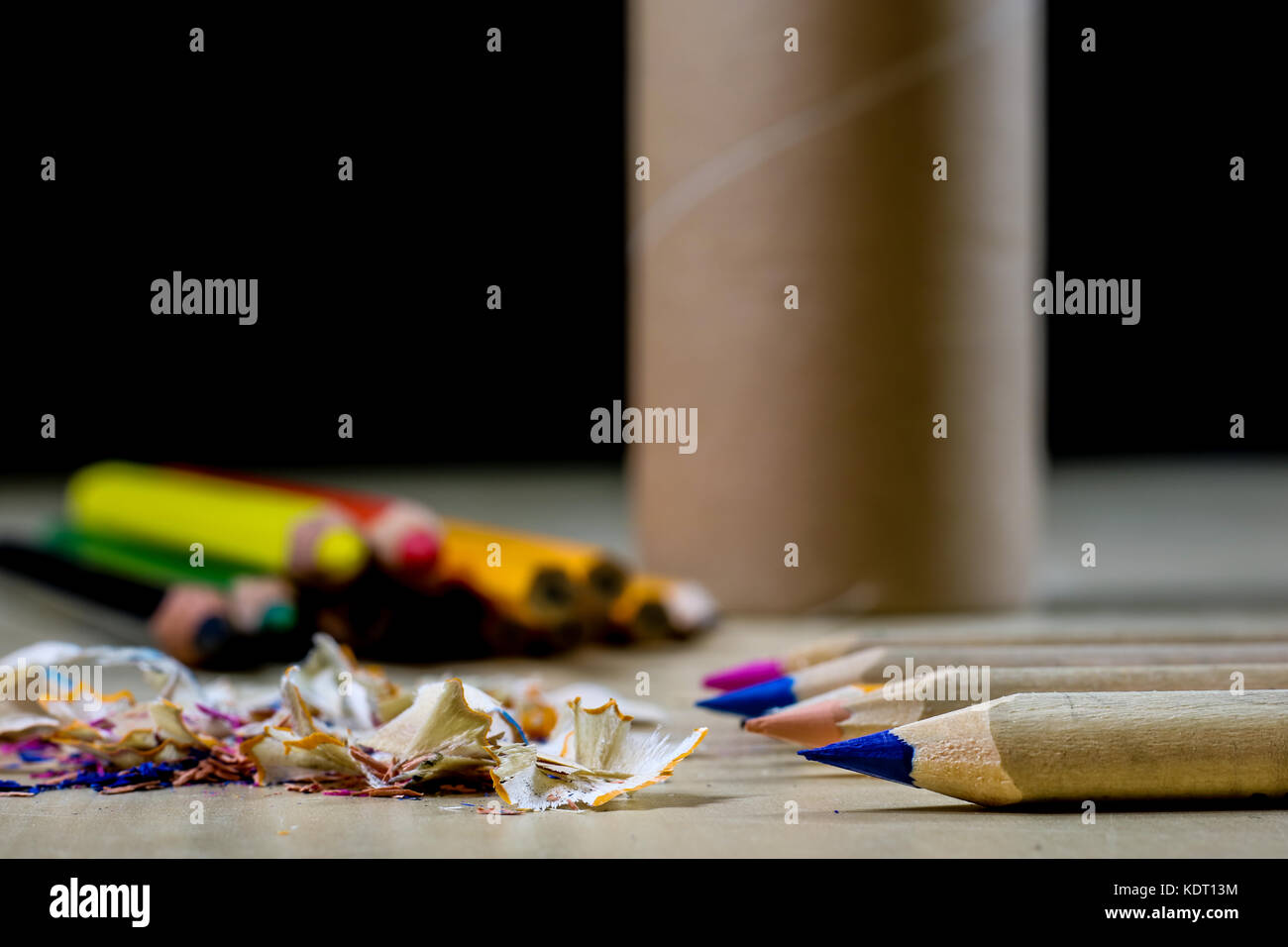 crayons and pencil sharpener on a wooden office table. Crayons with ...