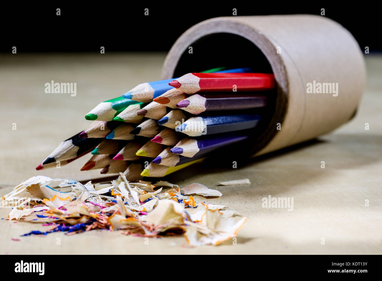 crayons and pencil sharpener on a wooden office table. Crayons with ...