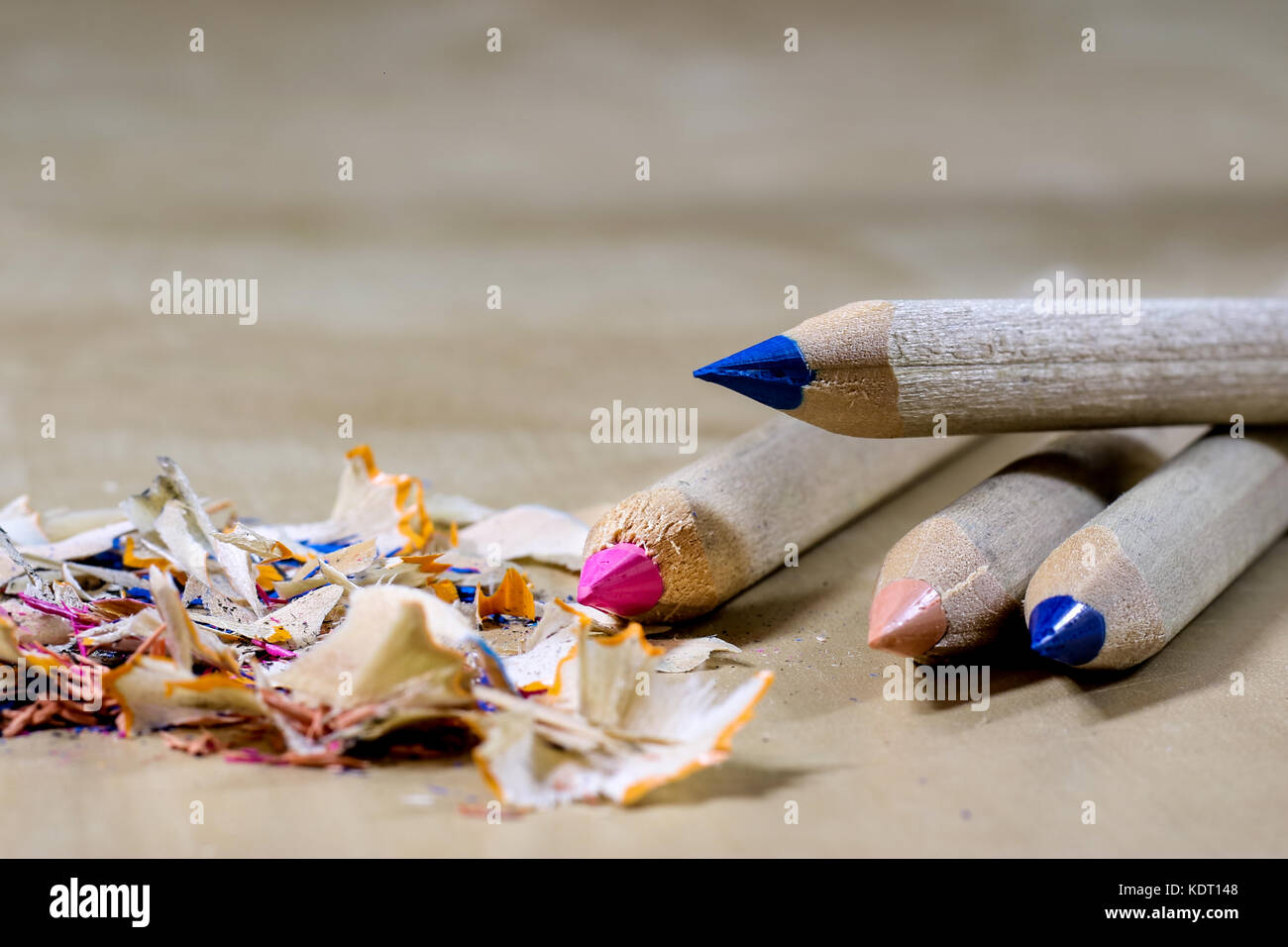crayons and pencil sharpener on a wooden office table. Crayons with ...