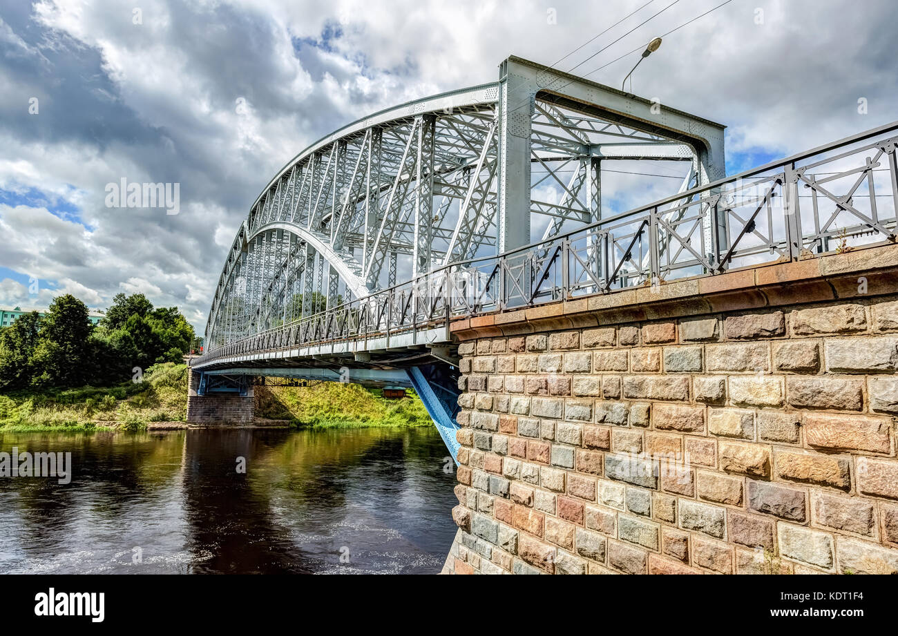 First in Russia steel arch bridge on river Msta in sunny summer day ...