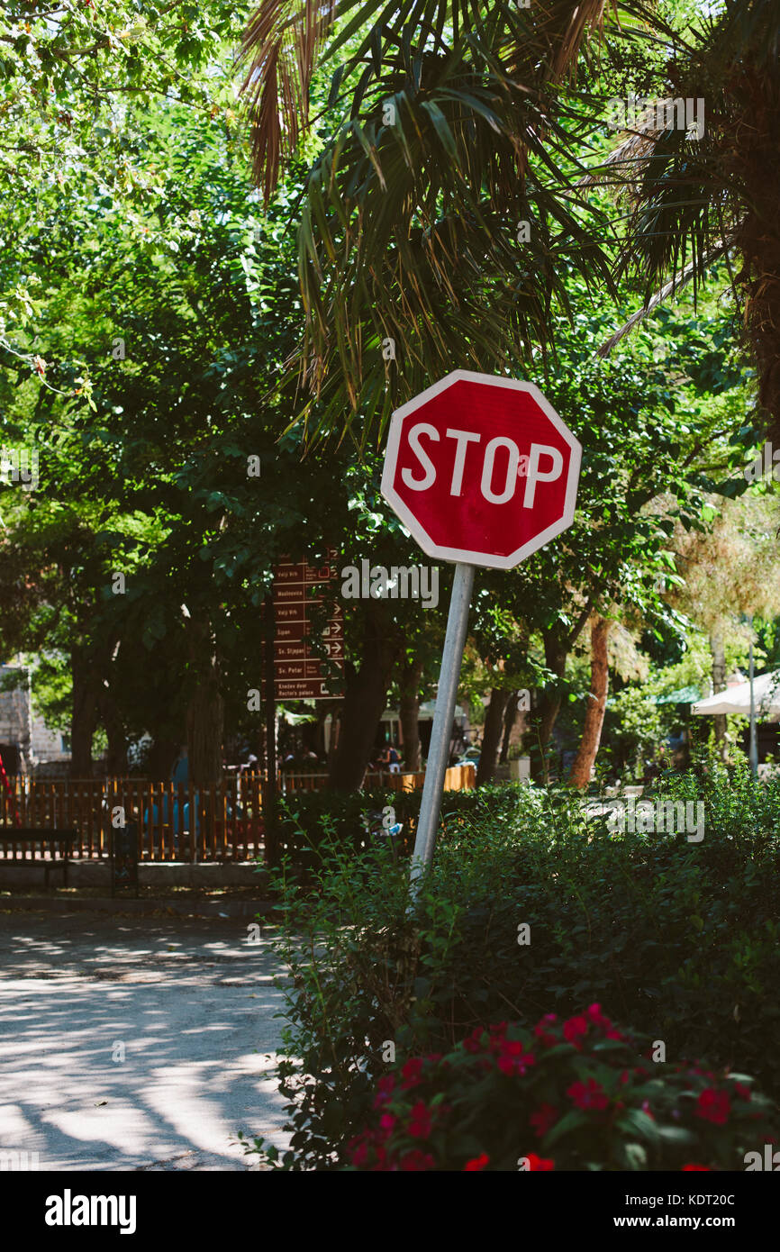 A red stop sign against leaves on a sunny day in Croatia Stock Photo ...