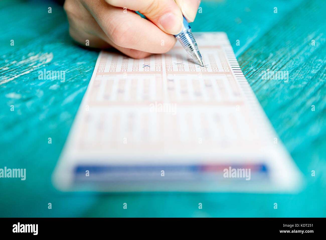 Image of man's hand with pen and lottery ticket Stock Photo - Alamy