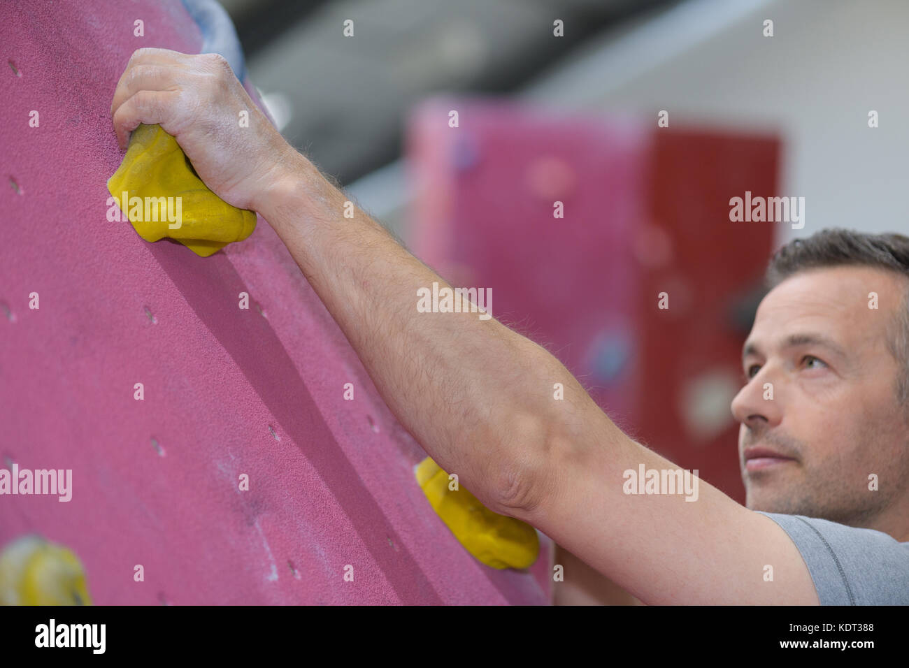 free climber young man climbing artificial boulder indoors Stock Photo ...