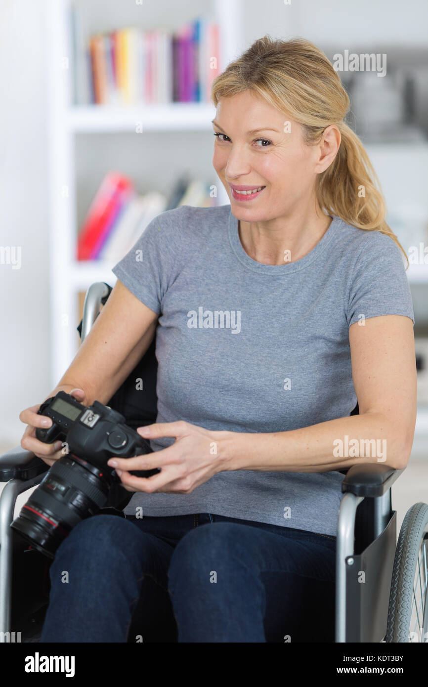 woman in wheelchair using a camera Stock Photo - Alamy
