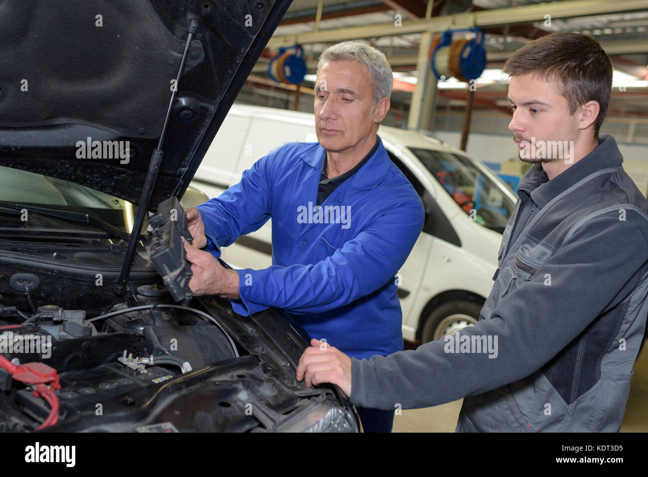 auto mechanic teacher and trainee performing tests at mechanic school ...