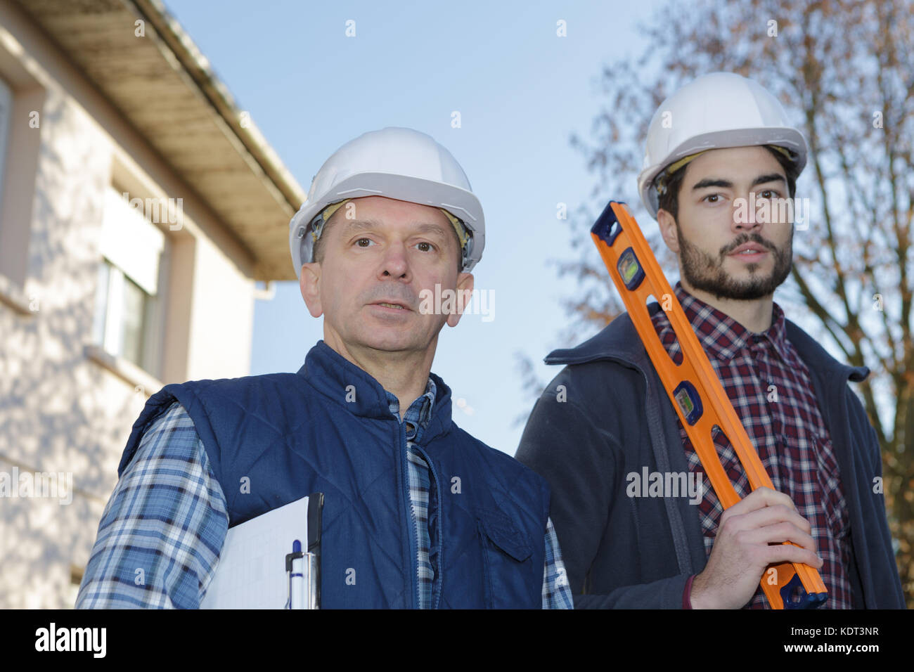workers with spirit level Stock Photo - Alamy