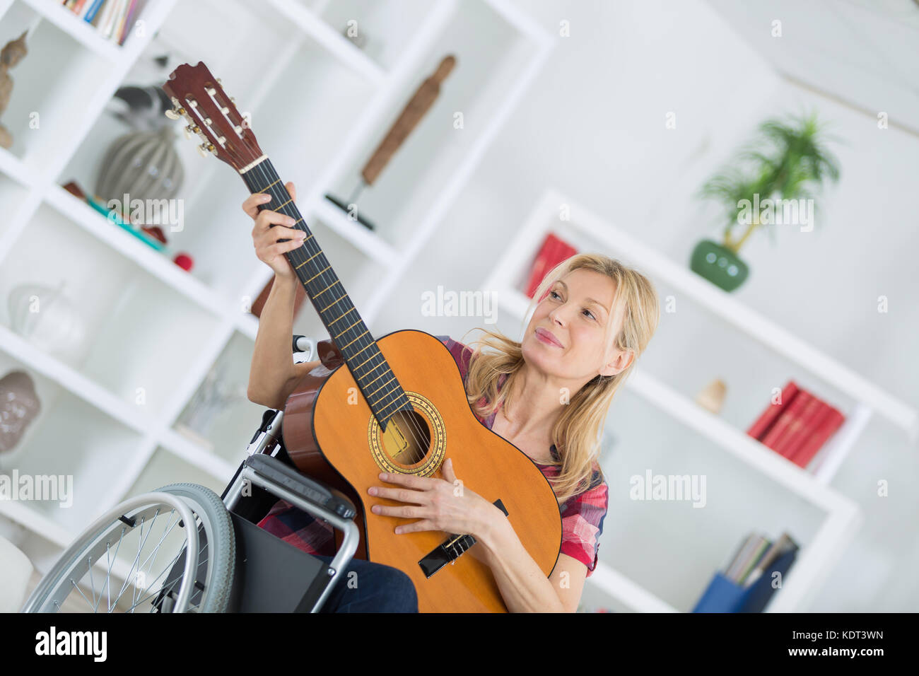 Disabled lady playing accoustic guitar Stock Photo - Alamy