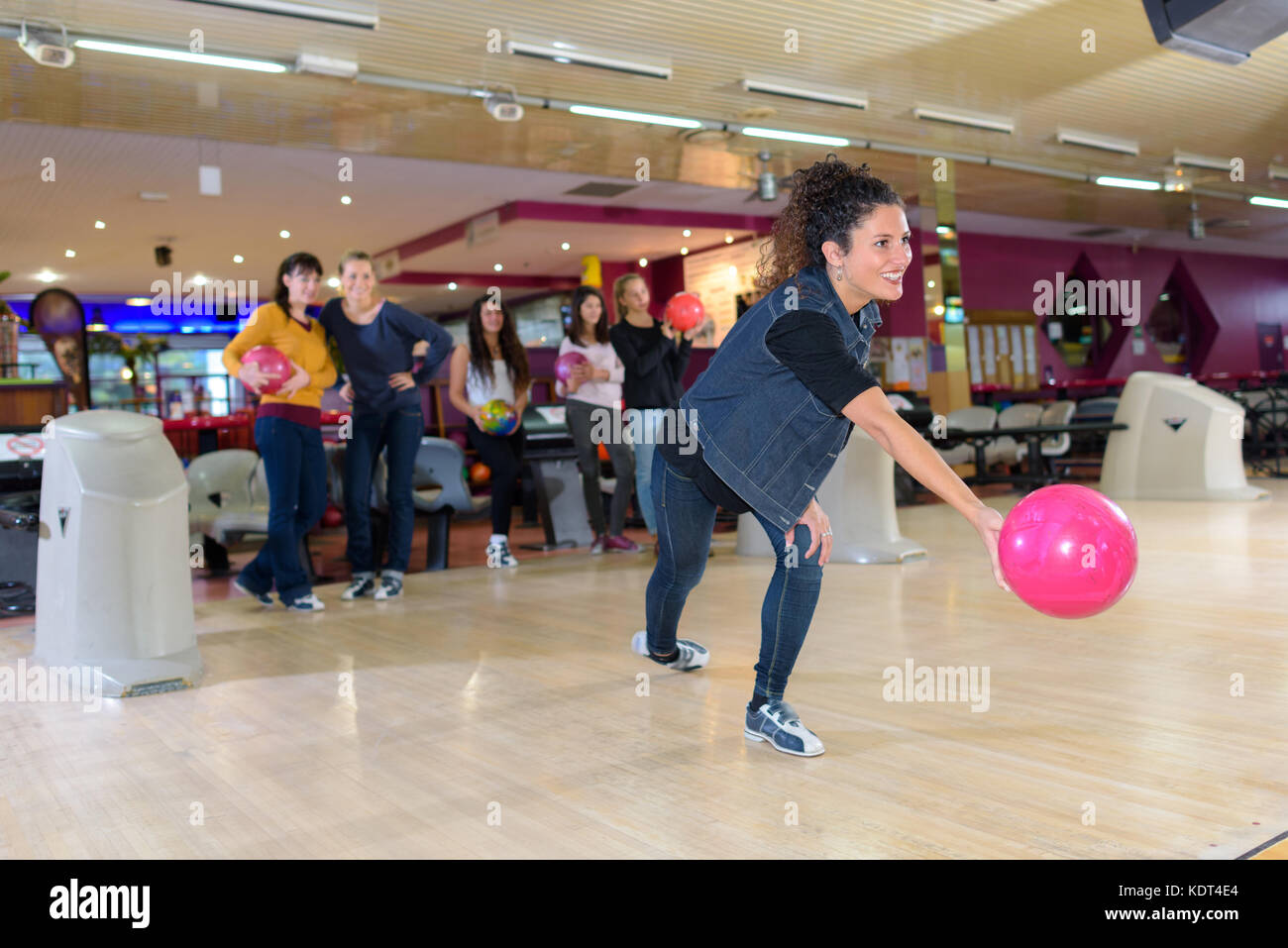 Lady launching bowling ball Stock Photo - Alamy