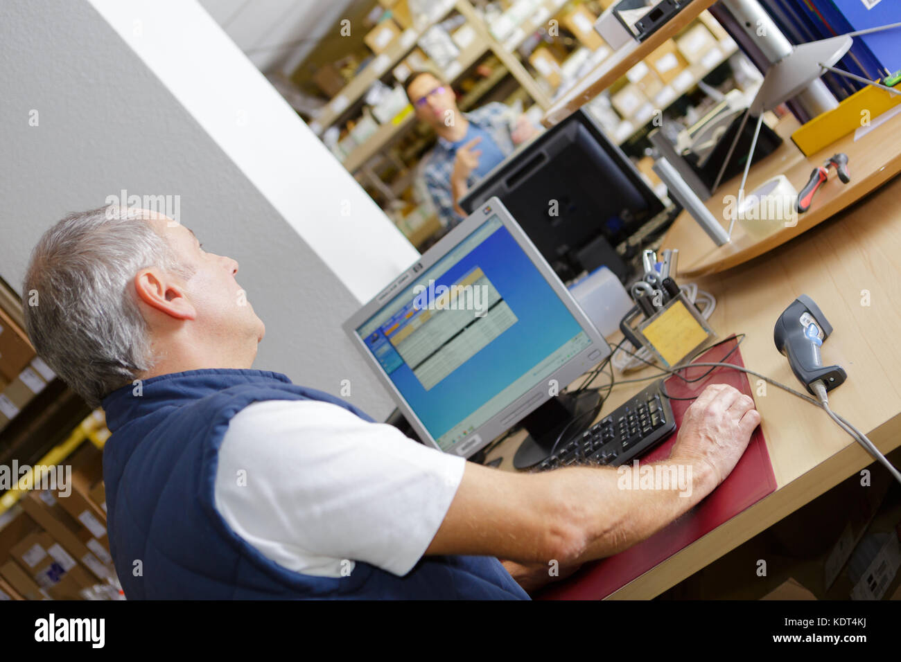 mature male worker at computer workstation Stock Photo - Alamy