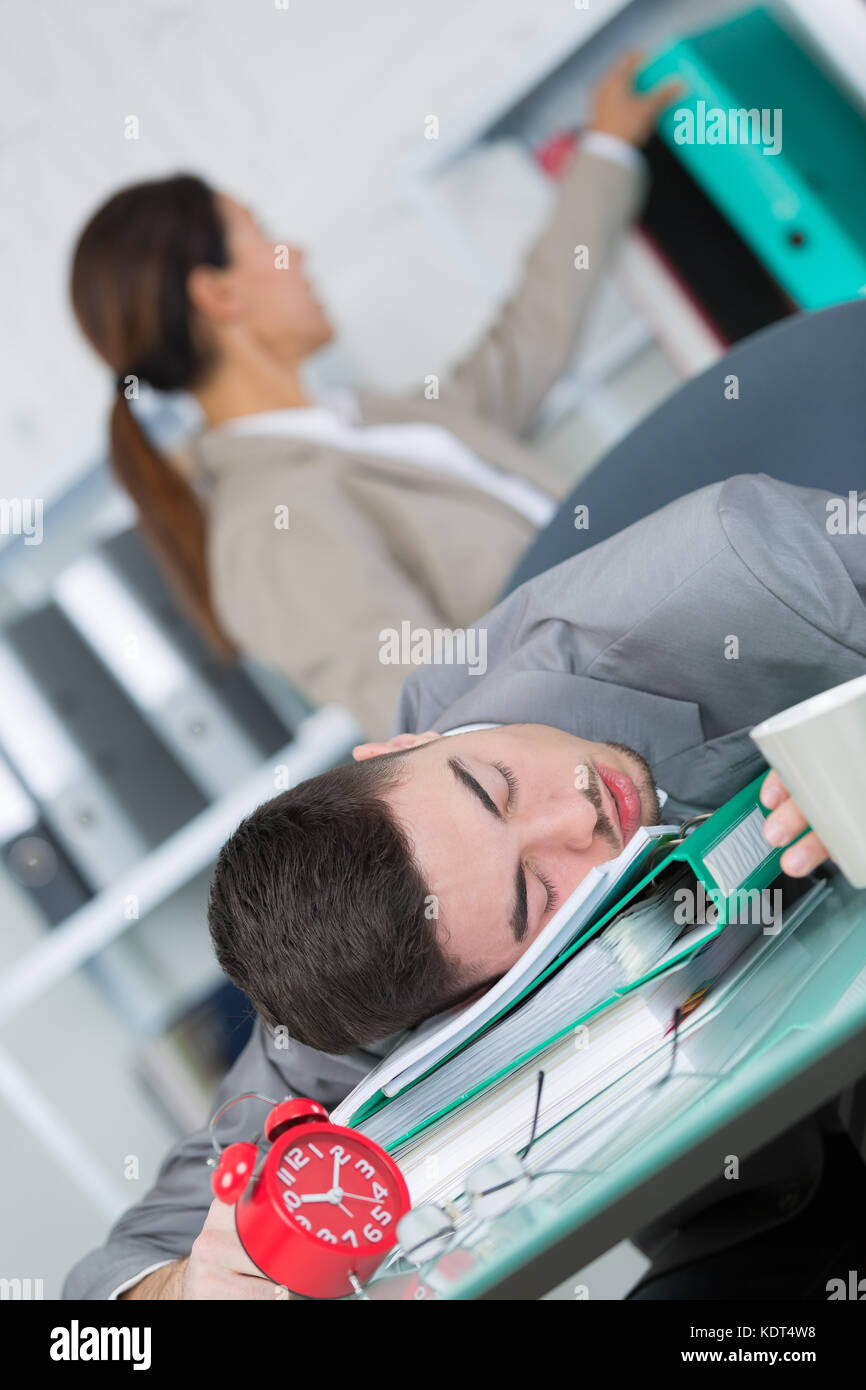tired young businessman sleeping in the office Stock Photo - Alamy