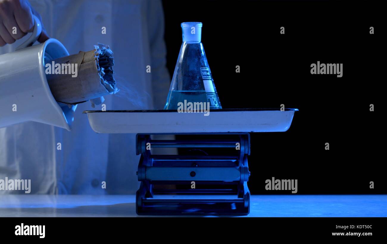 Bottle and liquid nitrogen in a laboratory. Chemical experiment. Flask ...