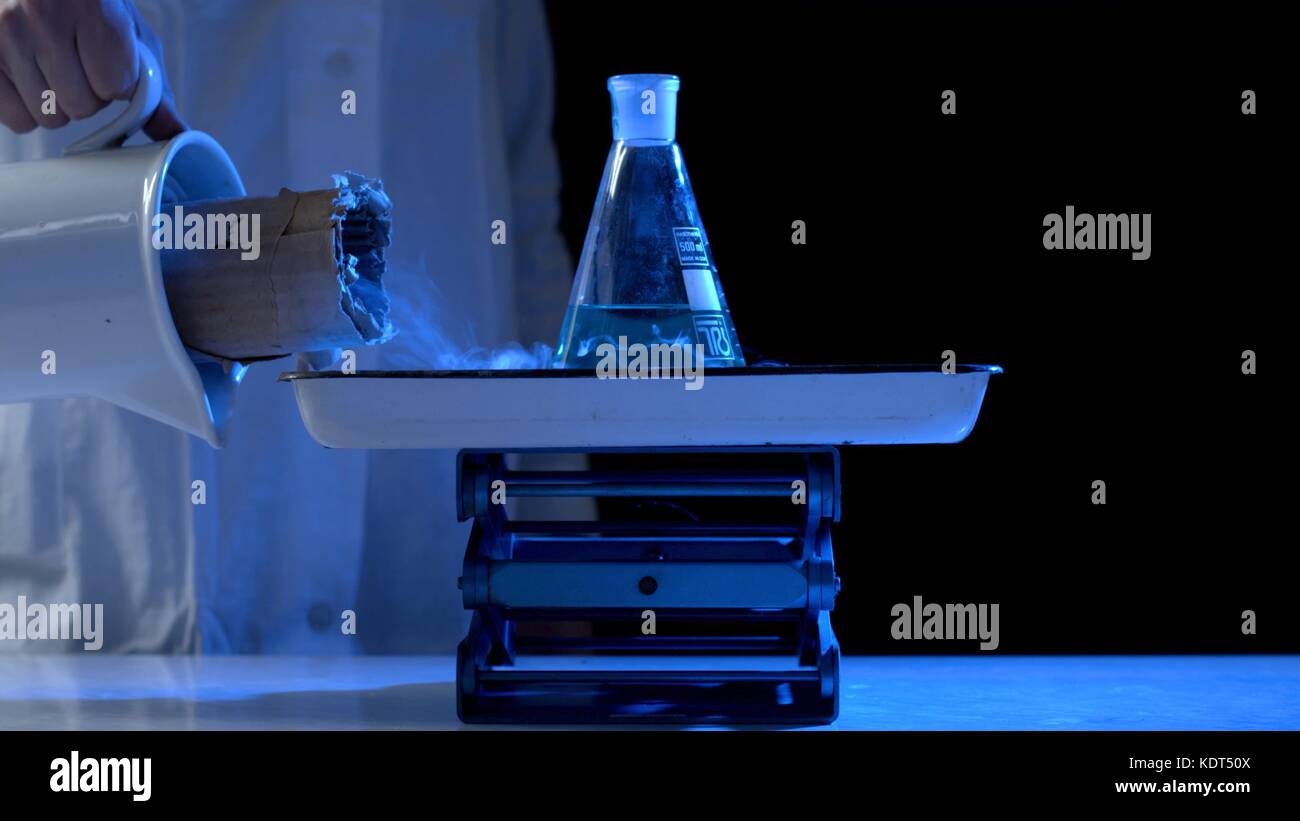 Bottle and liquid nitrogen in a laboratory. Chemical experiment. Flask ...