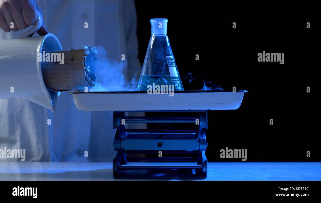 Bottle and liquid nitrogen in a laboratory. Chemical experiment. Flask ...