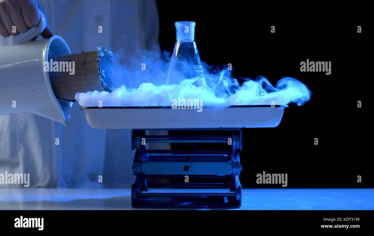 Bottle and liquid nitrogen in a laboratory. Chemical experiment. Flask ...