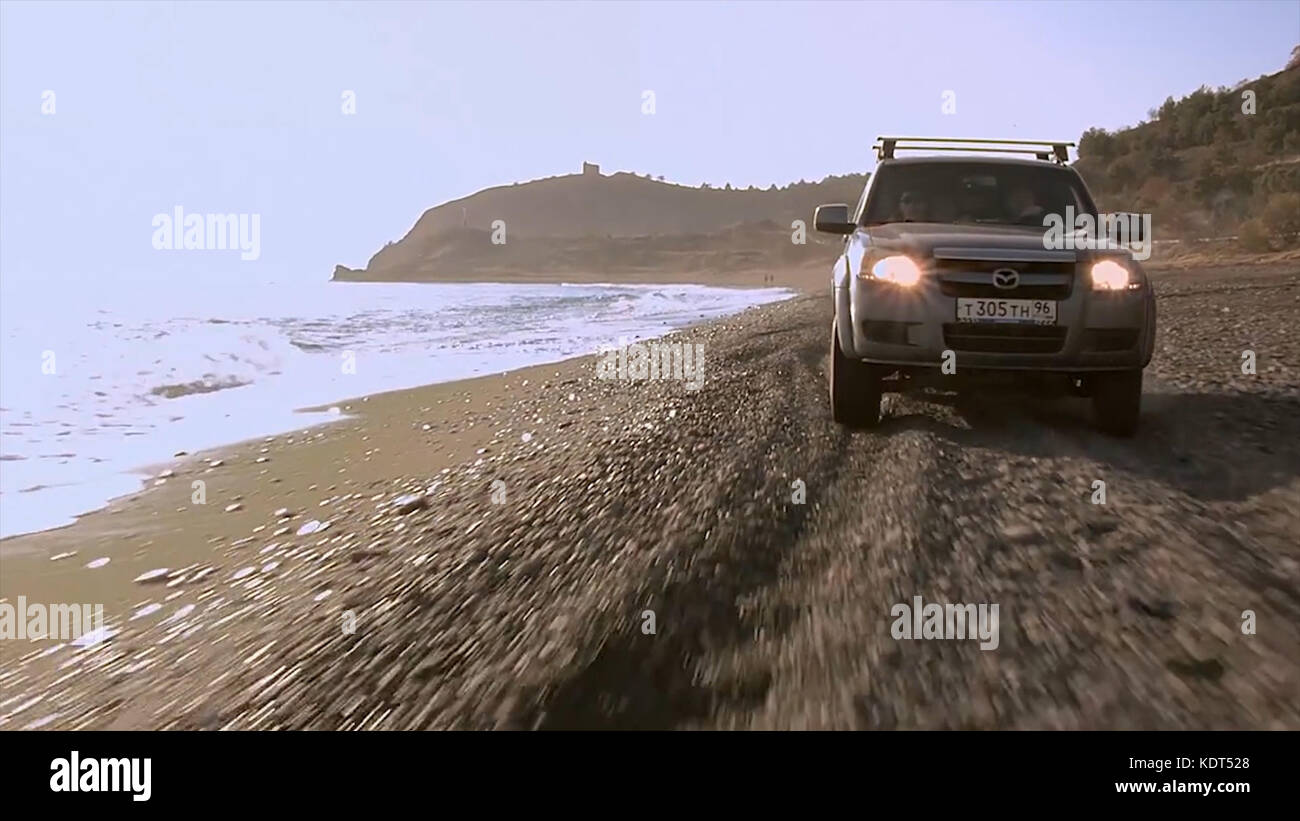 Tourist attraction Jeep ride at the beach during sunset. The SUV rides ...