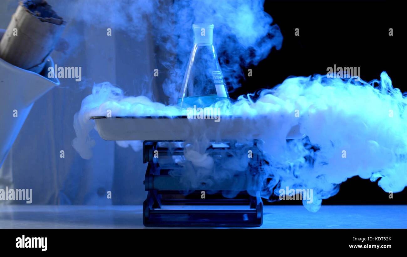 Bottle and liquid nitrogen in a laboratory. Chemical experiment. Flask ...