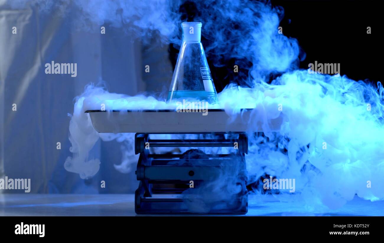 Bottle and liquid nitrogen in a laboratory. Chemical experiment. Flask ...